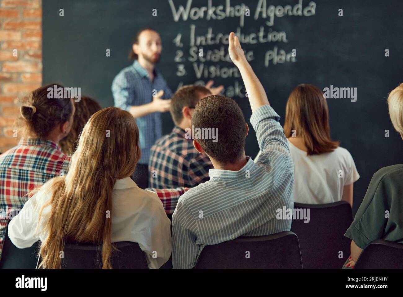 Person raising hand speaker hi-res stock photography and images - Alamy