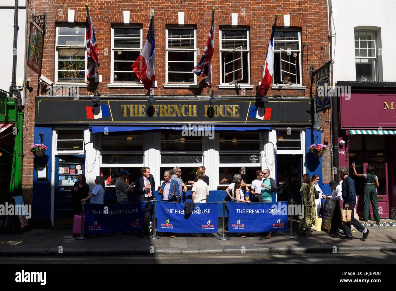 Afternoon drinkers, enjoying the sunshine outside, The French House Pub ...