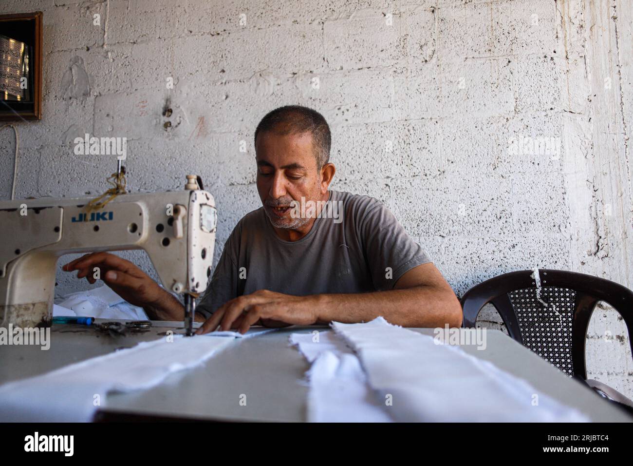 Gaza City, Palestine. 22nd Aug, 2023. A Palestinian tailor makes ...