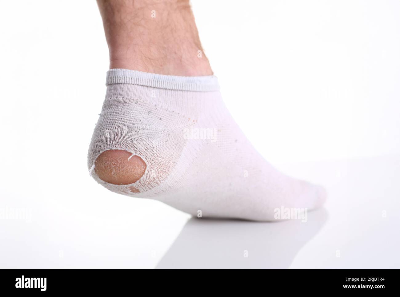 Ripped white sock on male leg isolated Stock Photo - Alamy