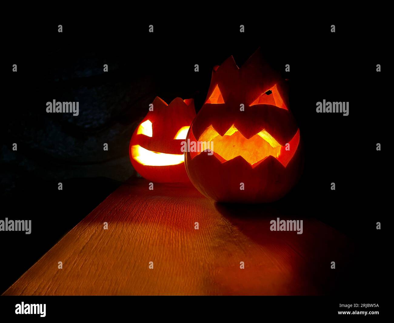 Two halloween pumpkins with faces and candles within Stock Photo - Alamy