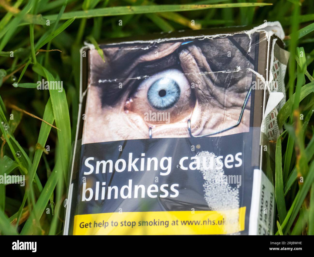A warning on a packet of cigarettes thrown away in Ambleside, Lake ...