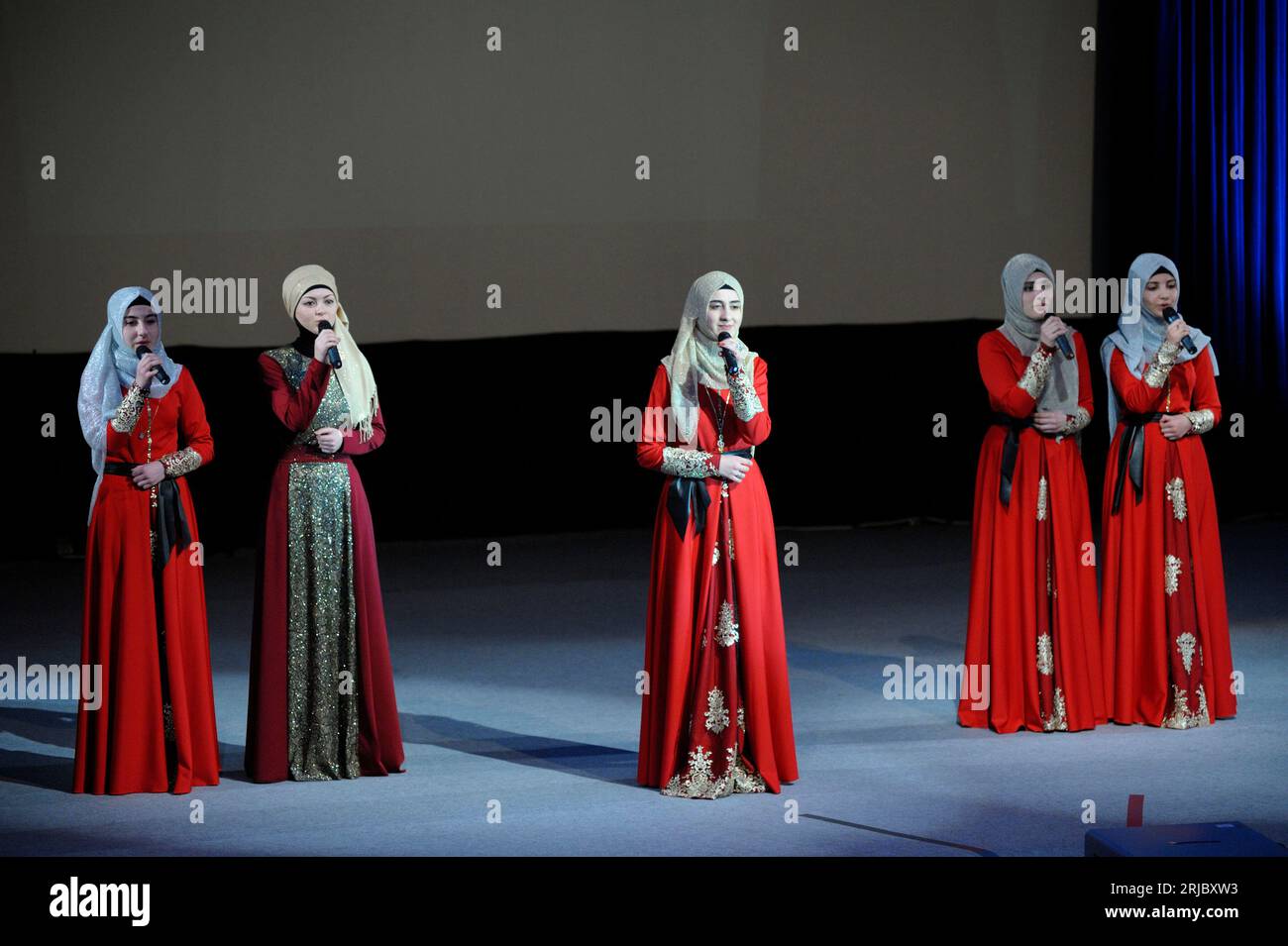 Group of young muslim women singing religious songs on stage during ...