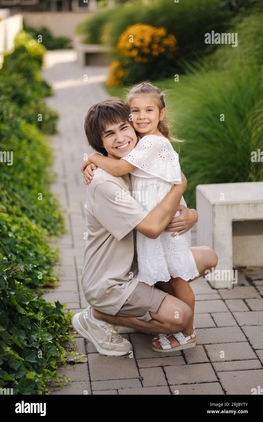 Portrait of happy and beautiful sister with her cousin. Adorable little girl and handsome ...