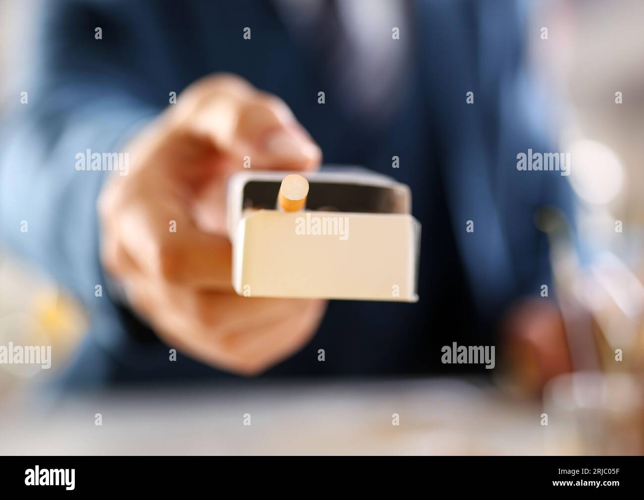 Male arm in suit offer pack of cigarettes Stock Photo - Alamy