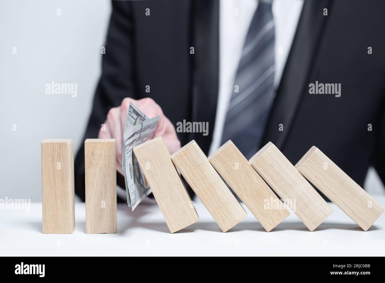 Wooden blocks under money dollars protection, domino, insurance safety ...