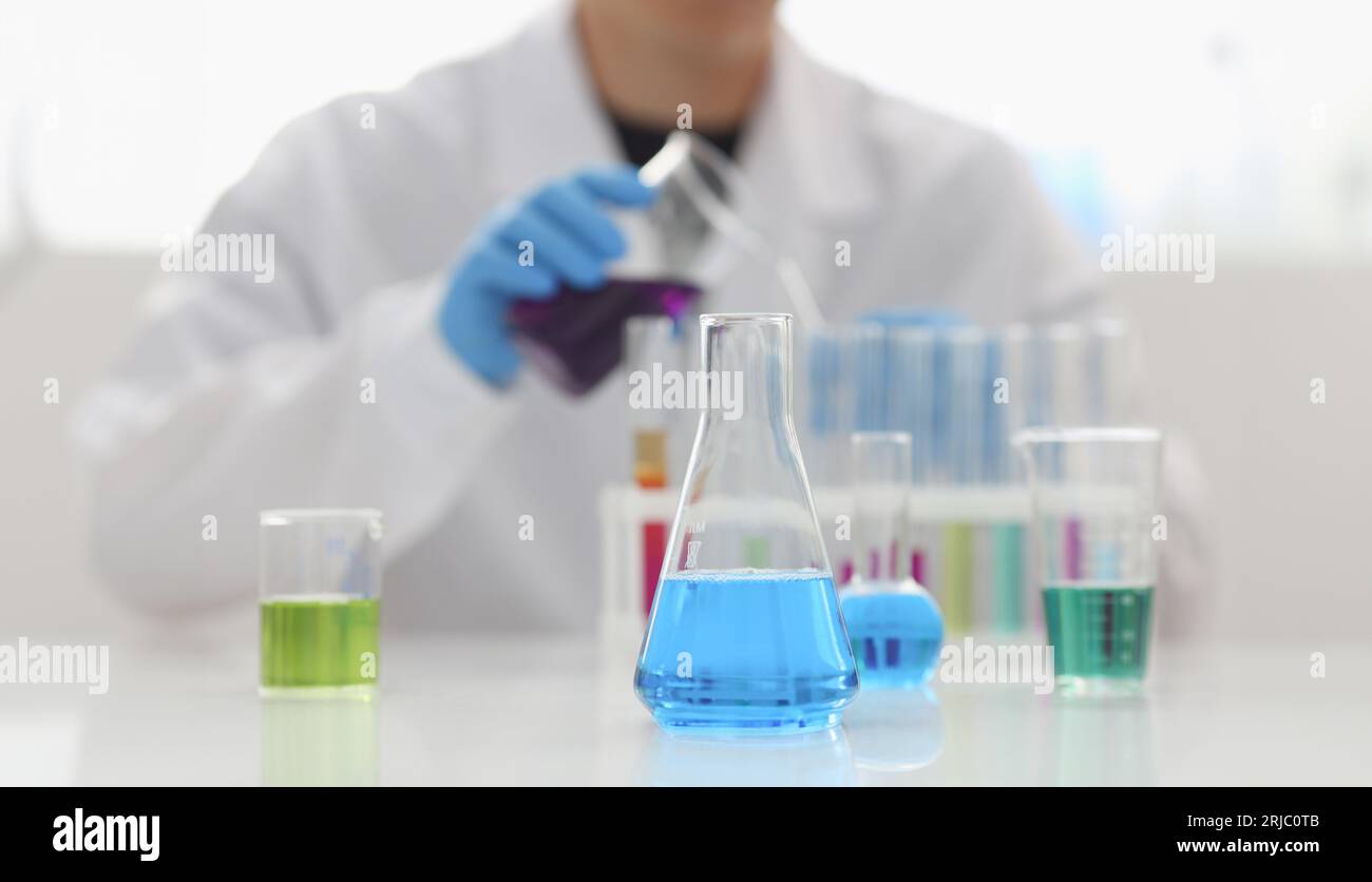 A male chemist holds test tube of glass Stock Photo - Alamy