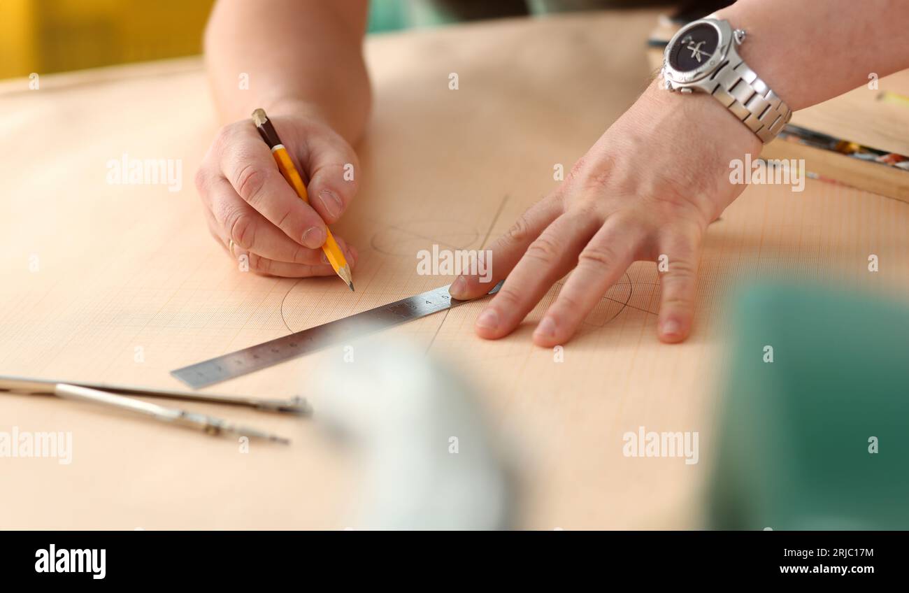 Arms of worker making structure plan Stock Photo - Alamy