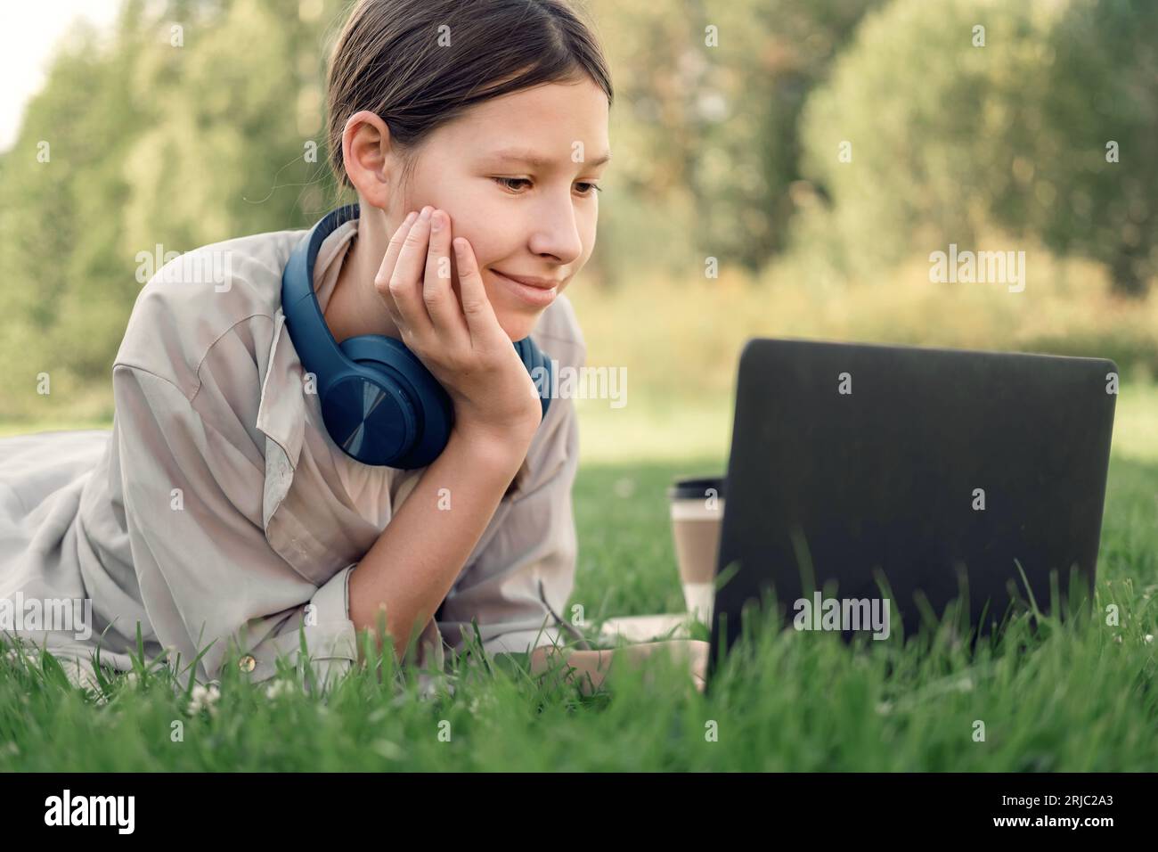 Teenage schoolgirl studying reading her books, tablet and notebook ...