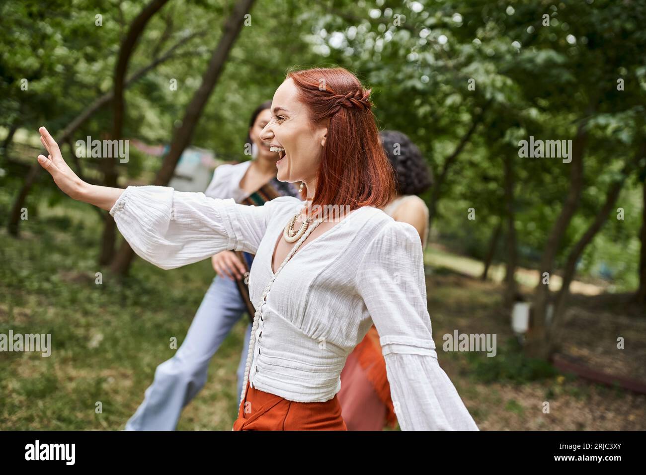 Cheerful Redhead Woman In Stylish Outfit Having Fun With Girlfriends In