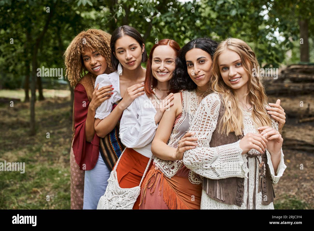 portrait of cheerful and stylish women in boho styled clothes looking ...
