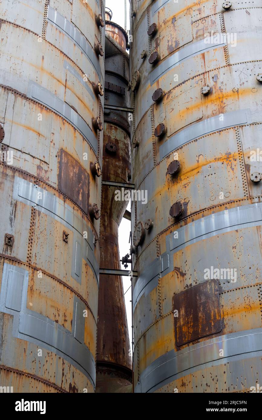 Close up view of some rusted steel tanks of an abandoned and ...