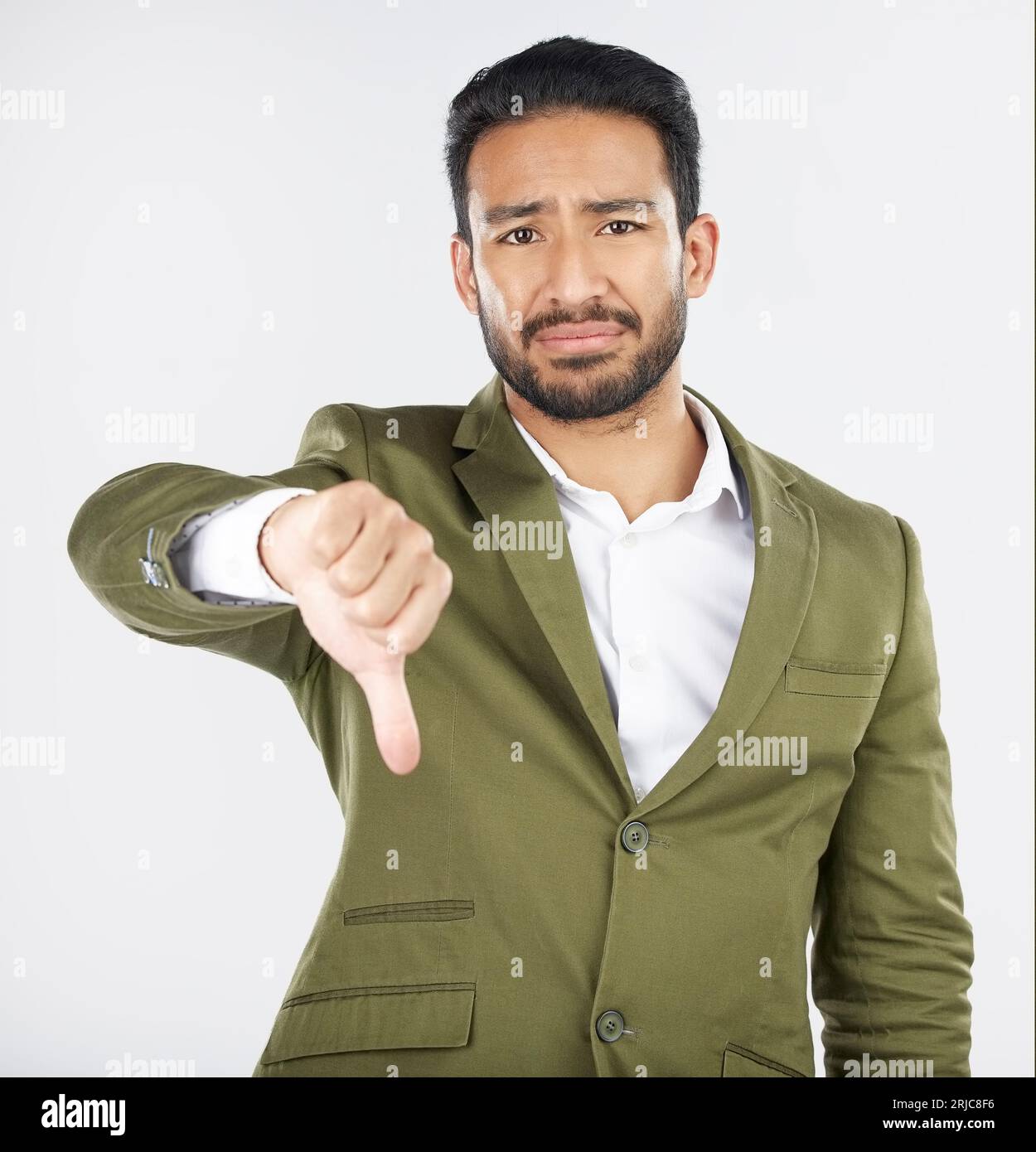 Sad, portrait and man with thumbs down in studio for rejection, no or ...