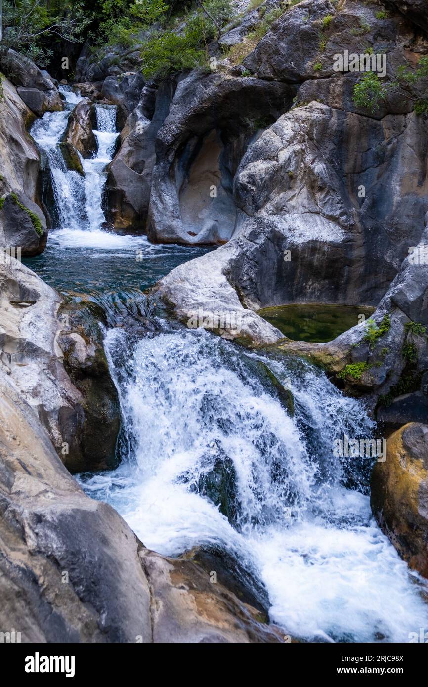 A beautiful mountain gorge with a river and a waterfall Stock Photo - Alamy