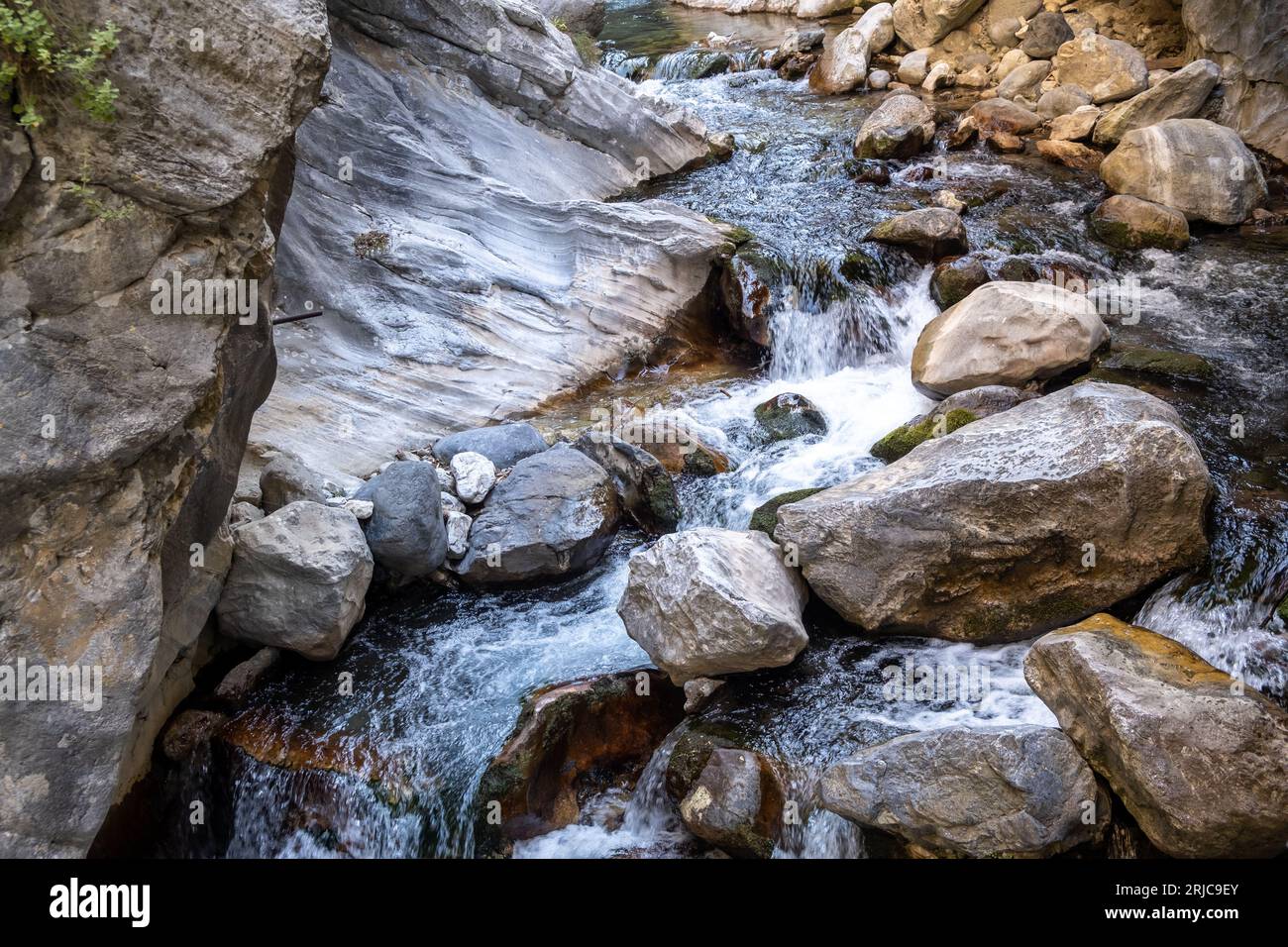A beautiful mountain gorge with a river and a waterfall Stock Photo - Alamy