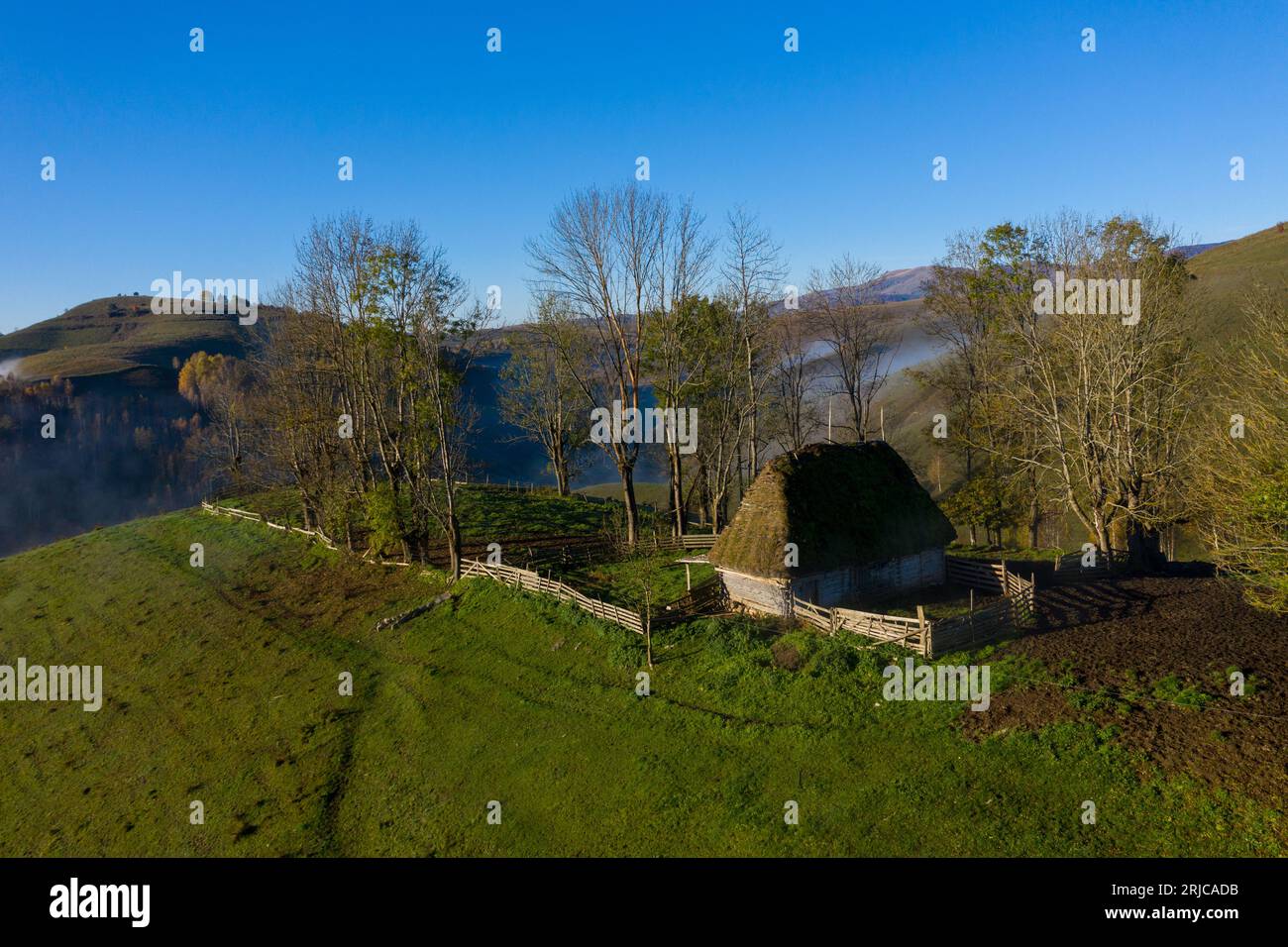 Aerial view of a mountain homestead in the autumn in early morning ...