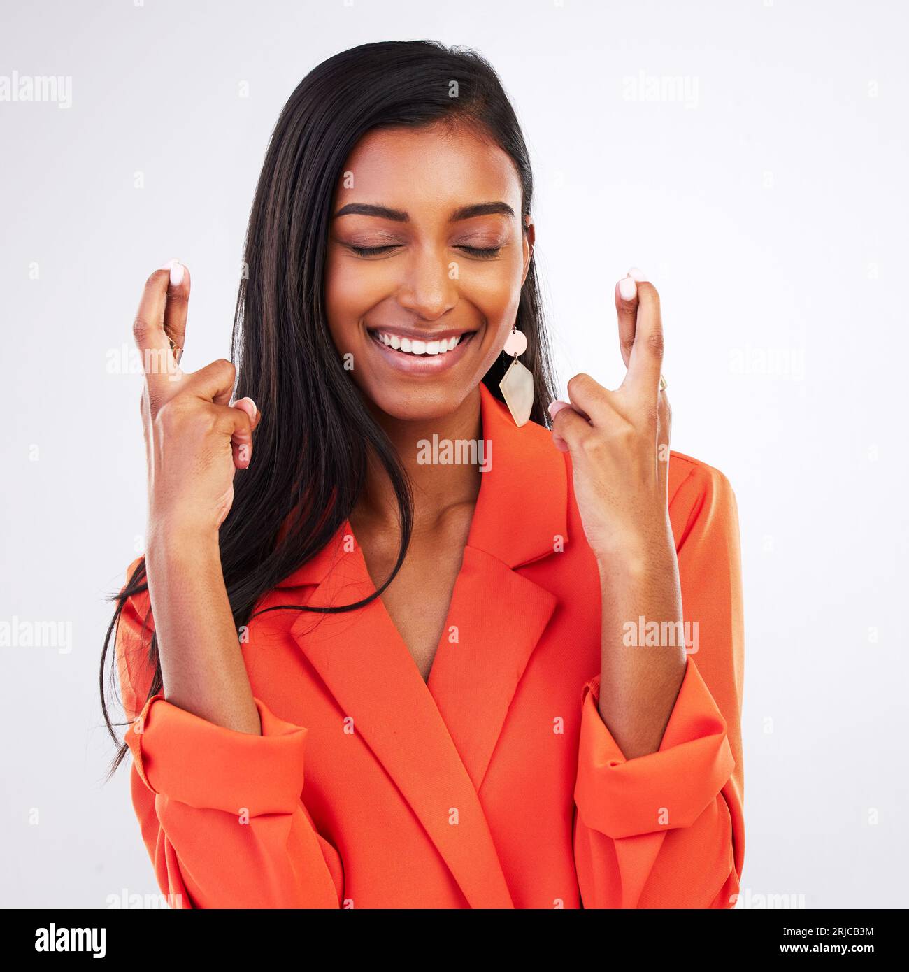 Face, smile and woman with fingers crossed in studio for good luck ...