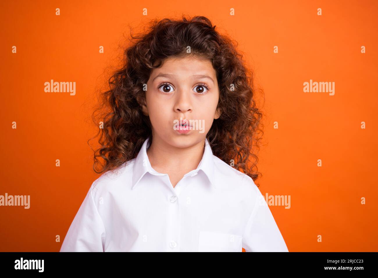 Photo of impressed sweet schoolkid pouted lips unbelievable unexpected ...