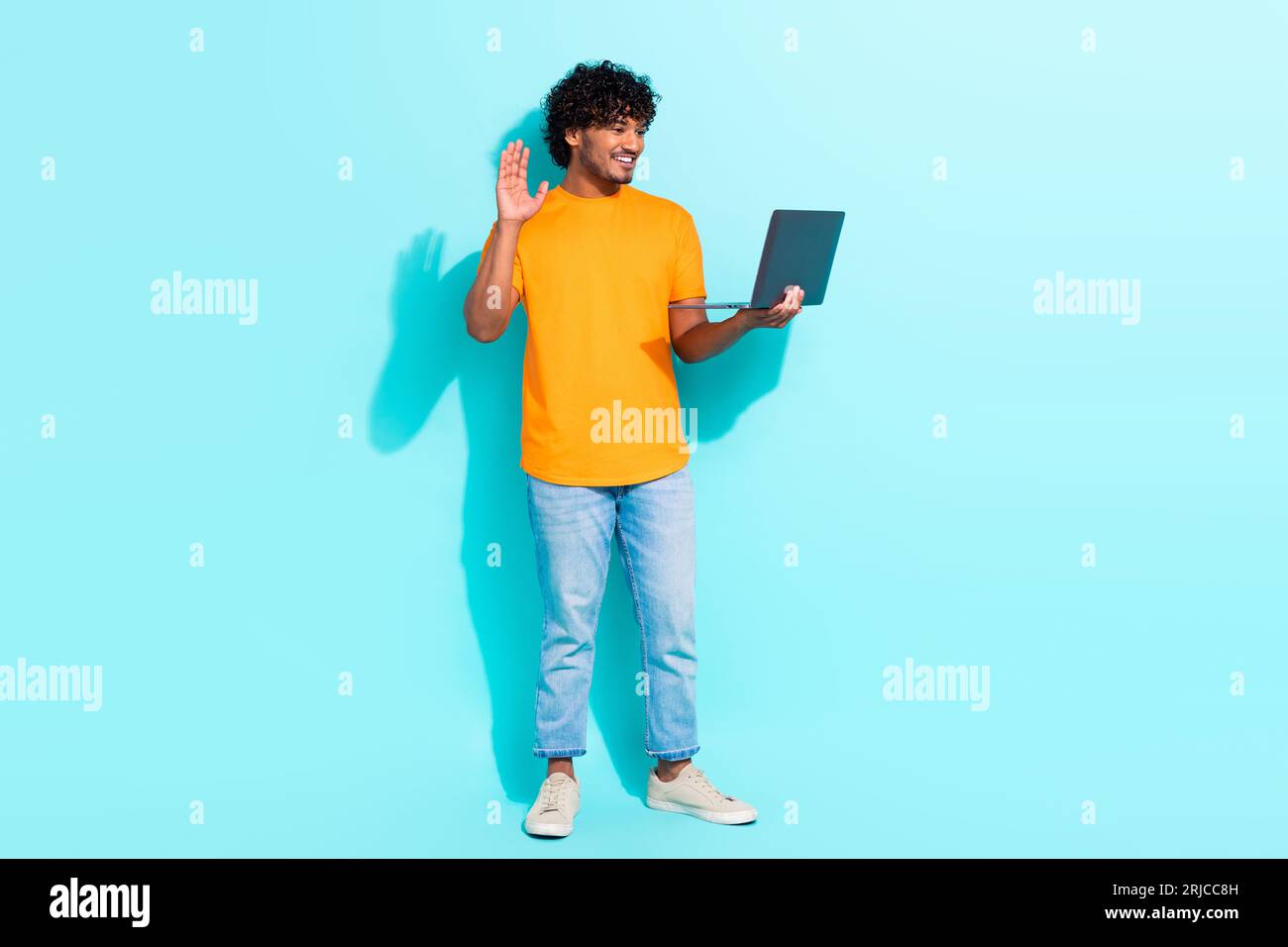 Full body length photo of young guy hands hello netbook video call ...