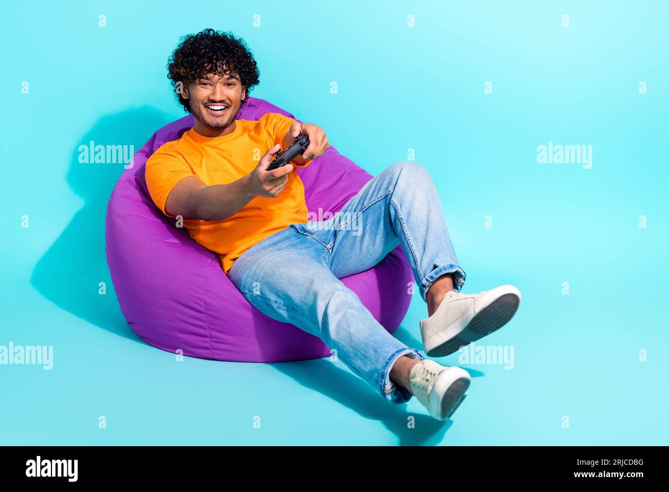 Full size photo of positive overjoyed person sit comfort bag hold ...