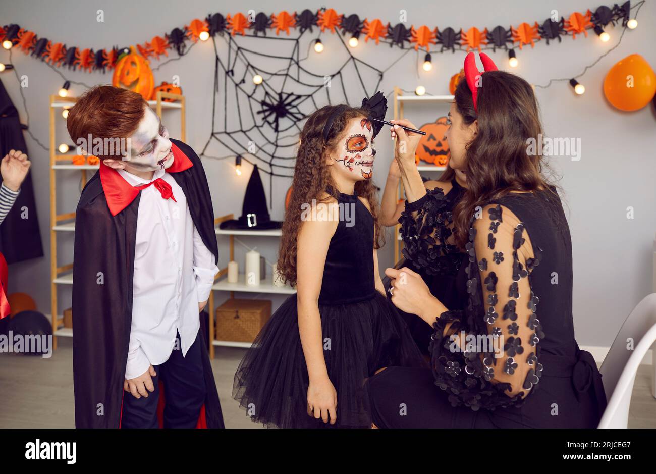 Teacher do makeup celebrate Halloween with kids Stock Photo - Alamy