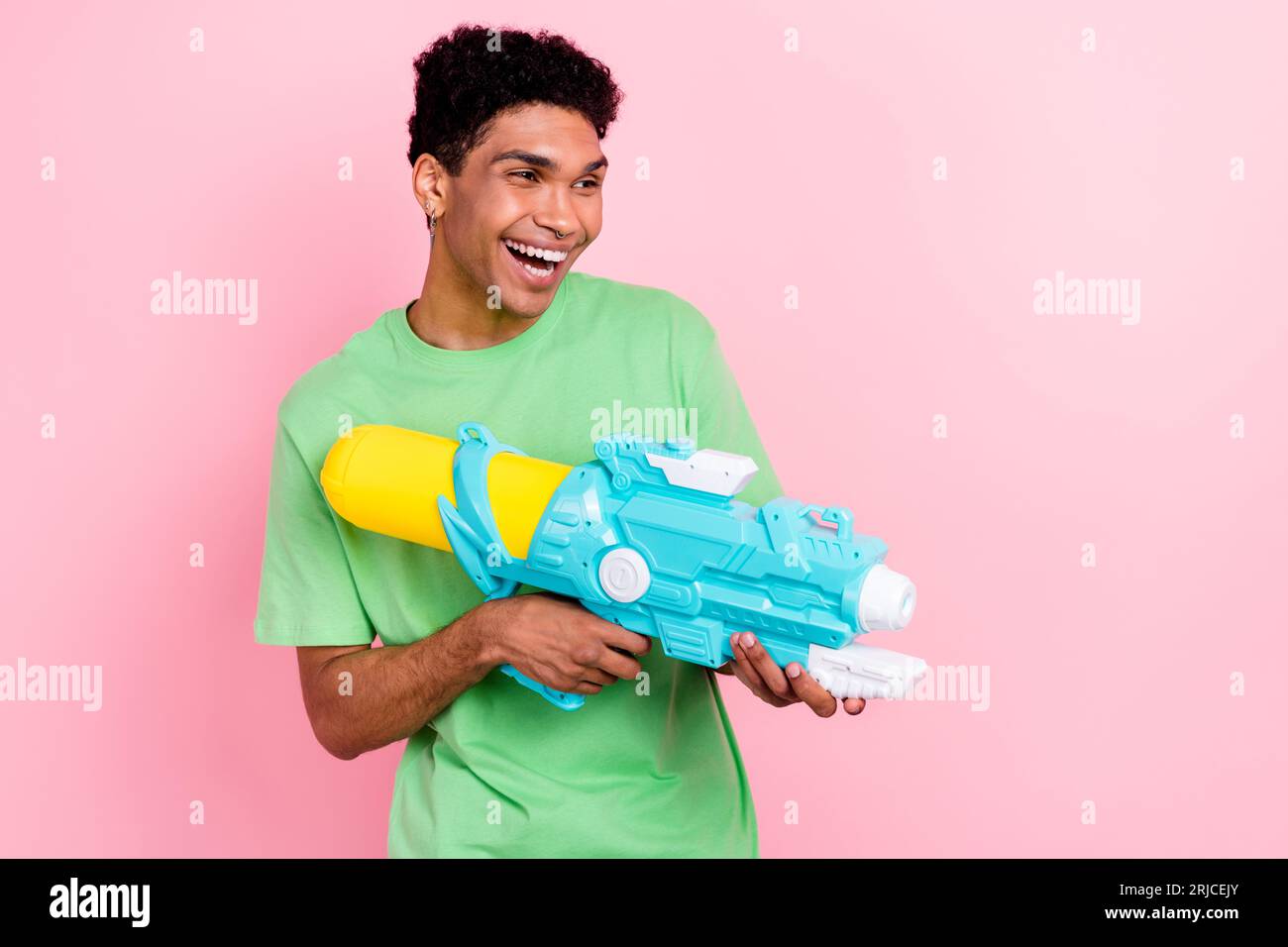 Photo of ecstatic eccentric guy with piercing dressed green t-shirt ...
