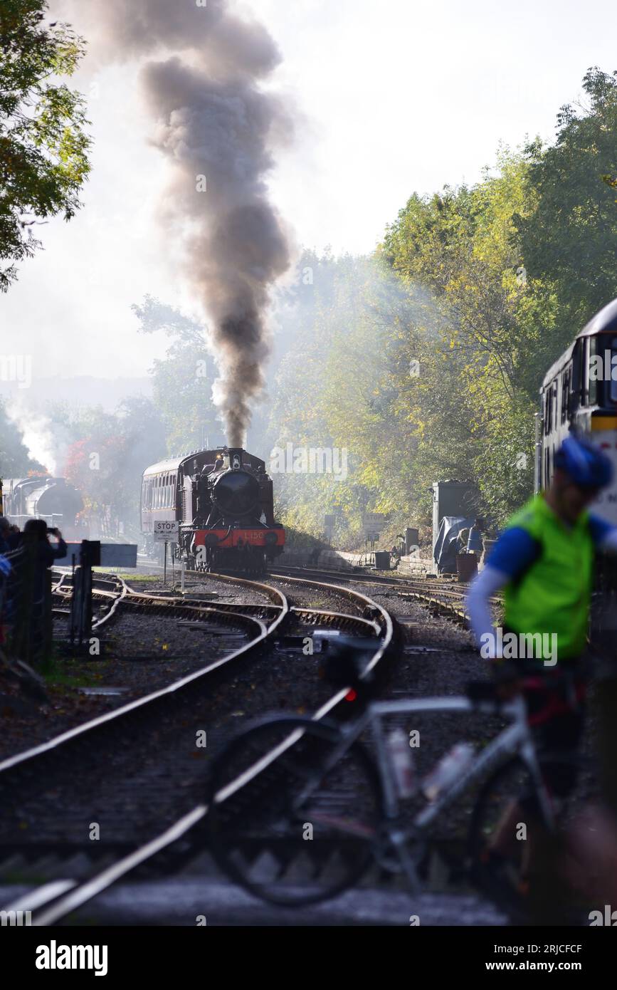A cyclist on a designated cycle path, crossing the Avon Valley Railway ...