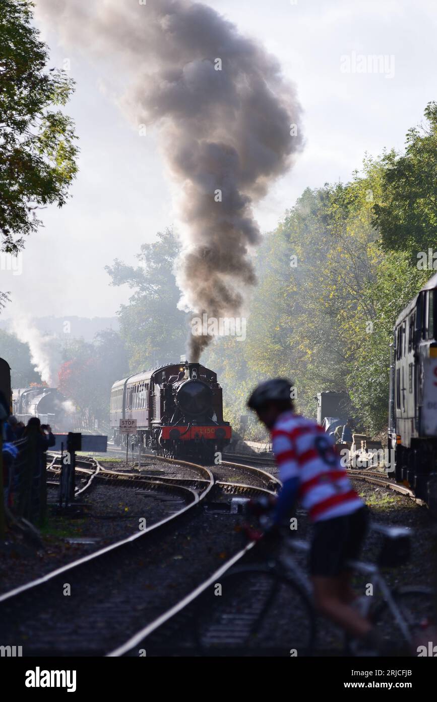 A cyclist on a designated cycle path, crossing the Avon Valley Railway ...