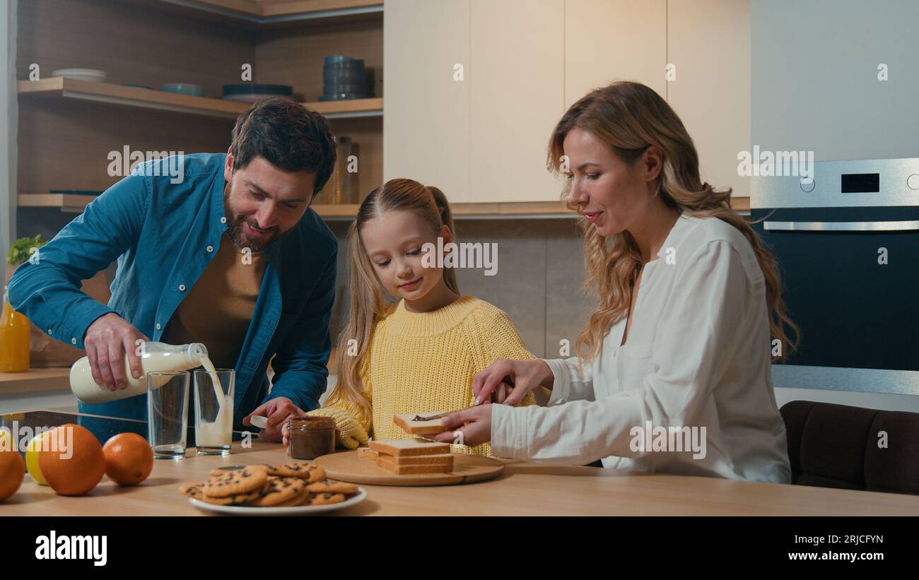 Caucasian happy family at kitchen morning breakfast with food delivery ...