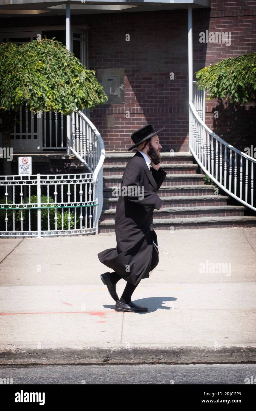 An orthodox Jewish man wearing high black stockings runs on Wallabout ...