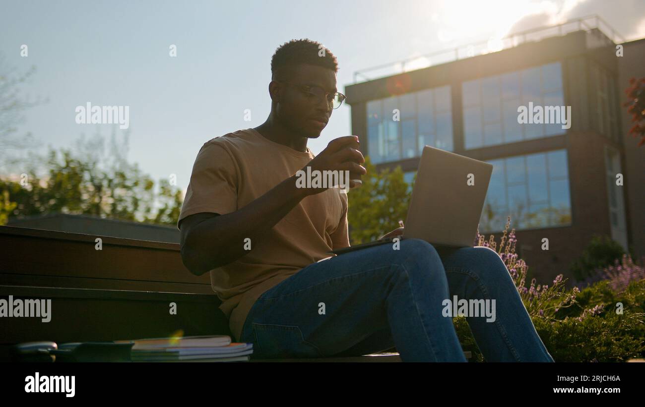 Outdoors studying African American man student guy teenager male study ...