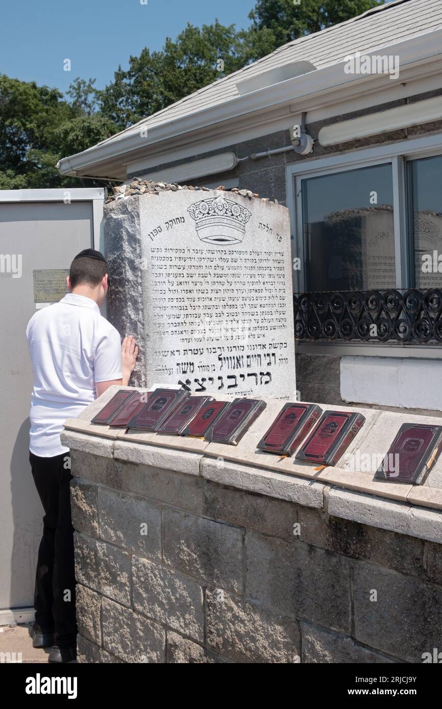 An orthodox Jewish man recites a personal prayer at a holy place, the ...