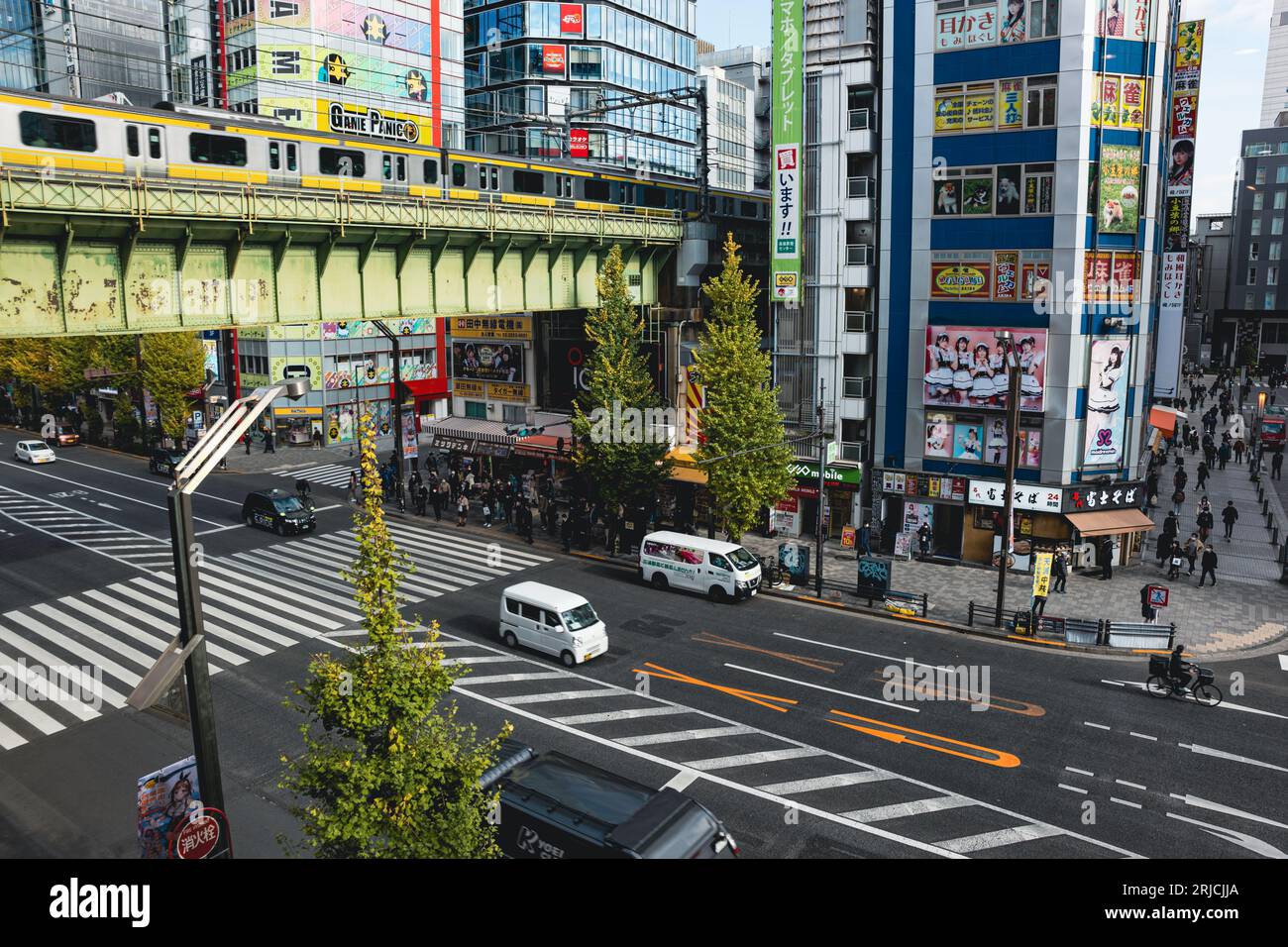 An aerial view of a bustling city in Japan, featuring a highway ...