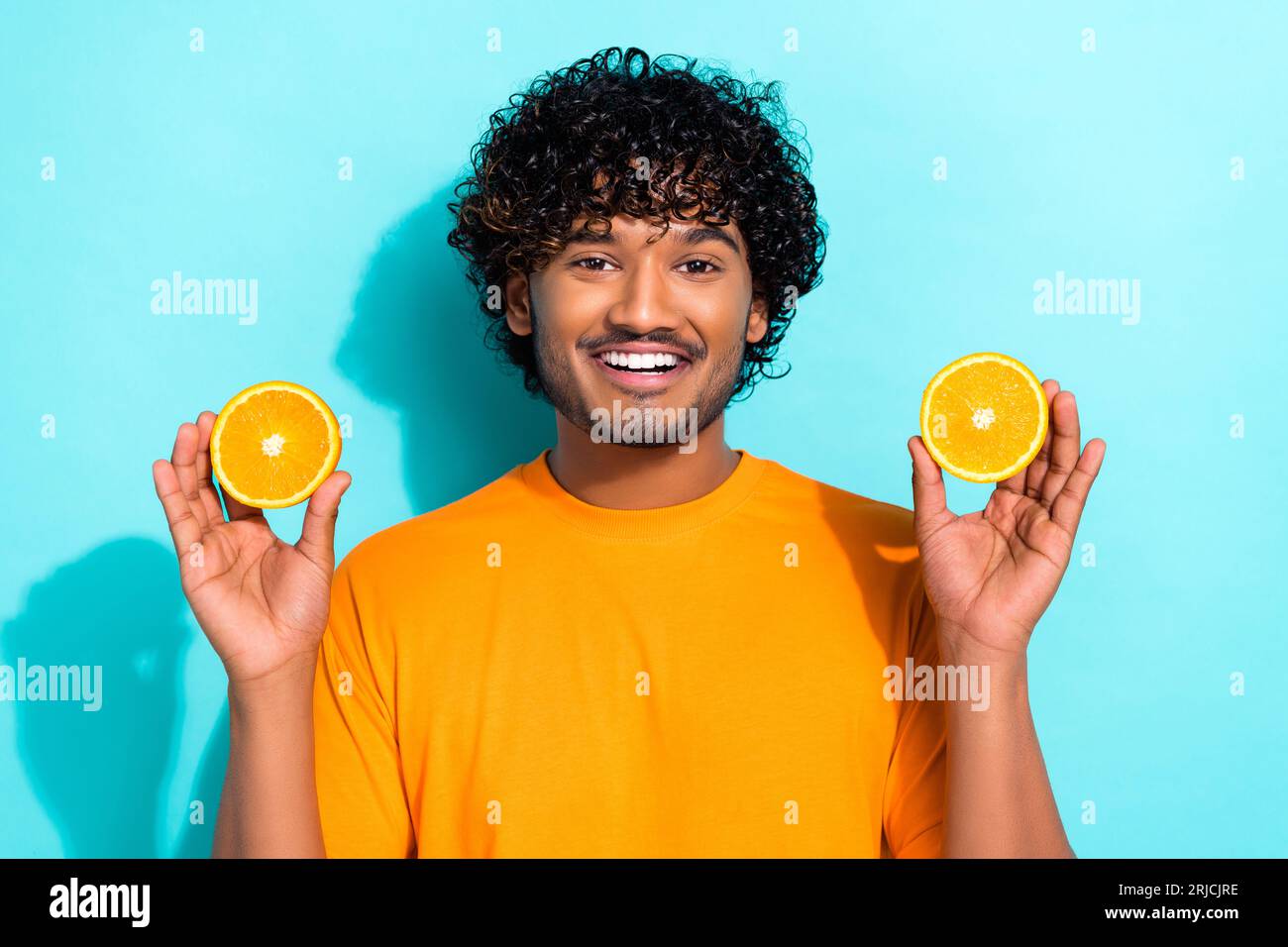 Photo of positive friendly person beaming smile hands hold two halves ...