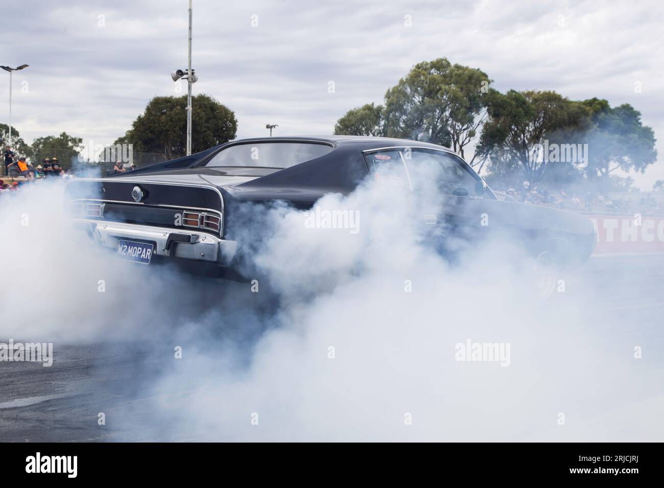 Dragway racing with heaps of smoke as cars rip down the track Stock ...