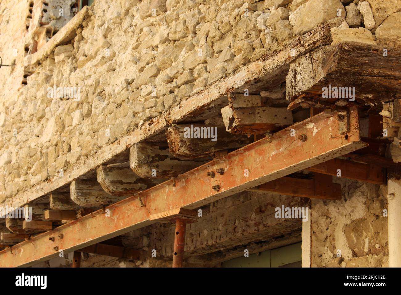very old medieval stone building with wooden beams needing to be held ...