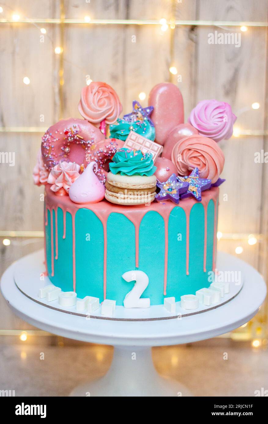 Birthday cake with turquoise frosting and pink birthday decorations ...