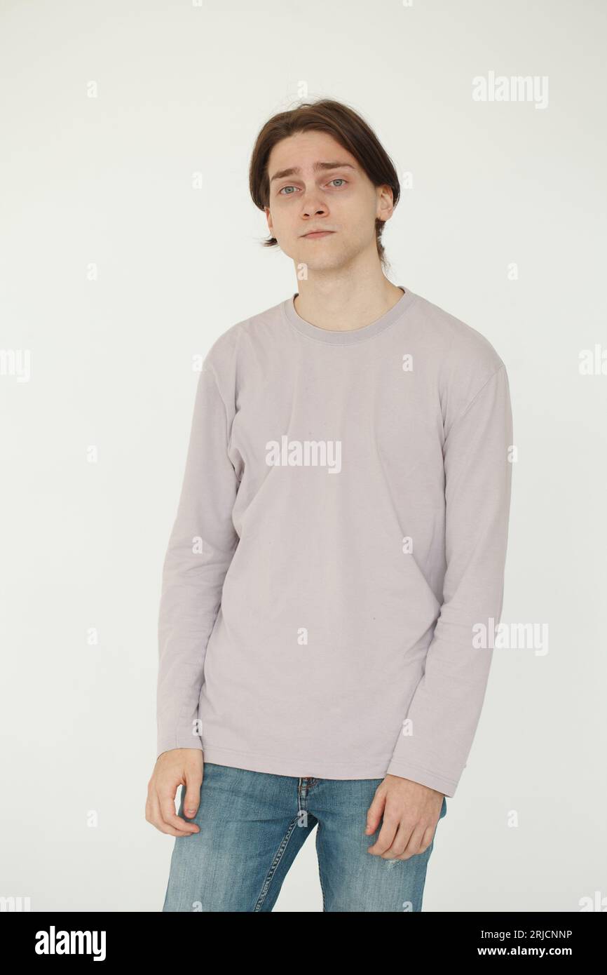 Frustrated stressed young man standing on white background Stock Photo ...