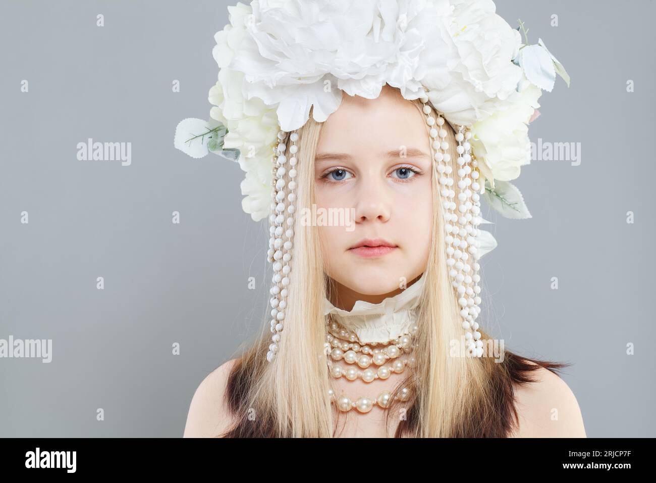 Beautiful young girl wearing white flowers wreath crown, fashion portrait Stock Photo - Alamy