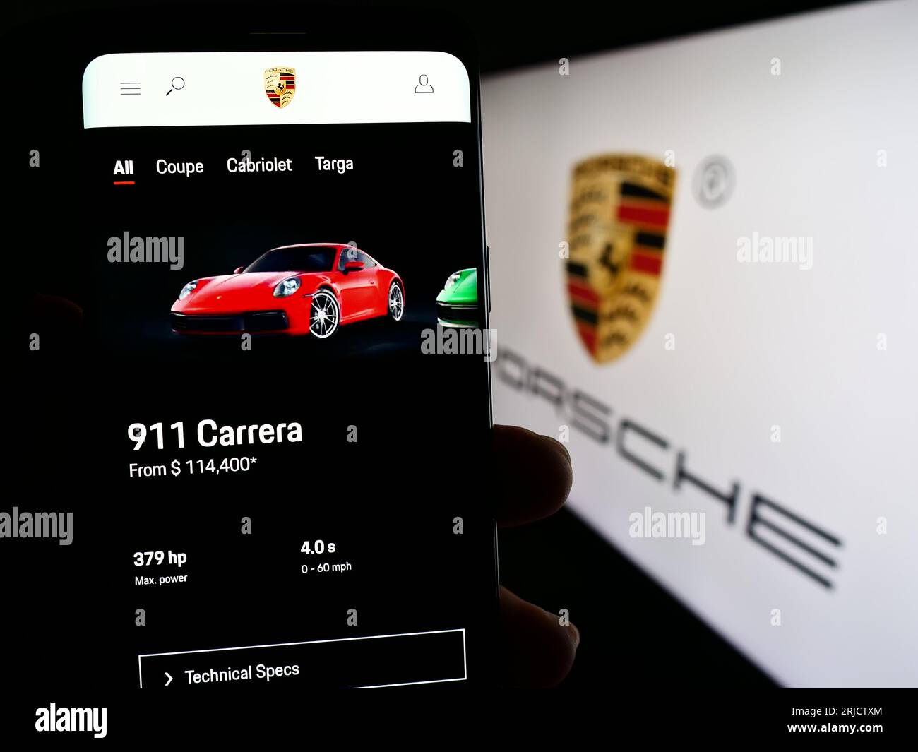 Person Holding Cellphone With Web Page Of Automotive Company Dr Ing Hc F Porsche Ag On