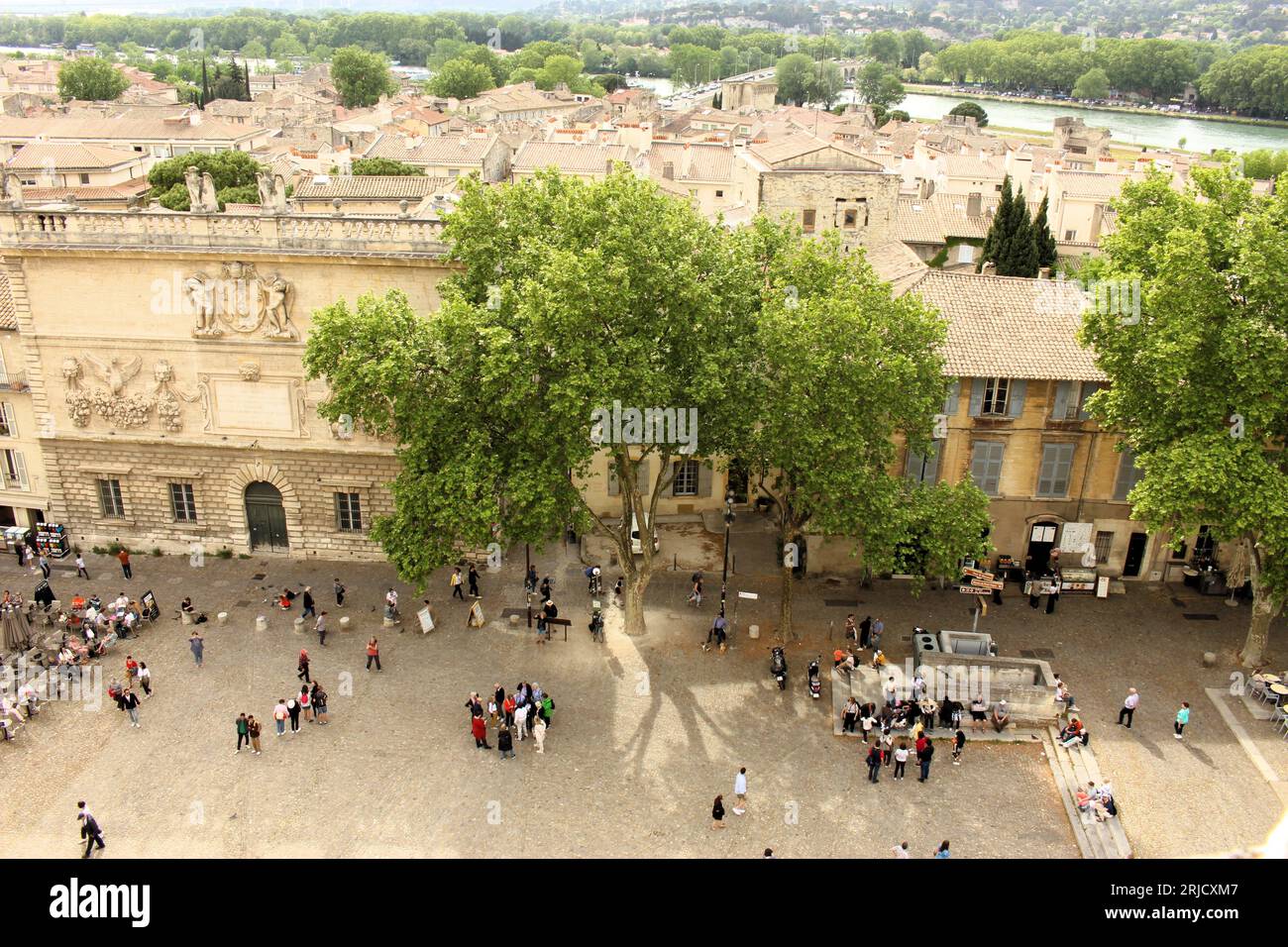 People milling about in a public town square in Avignon, France in ...
