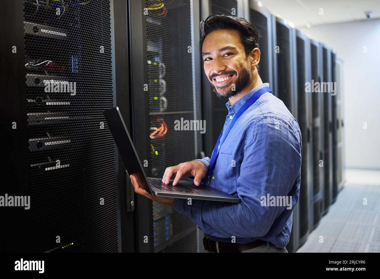 Man, engineering computer and server room, data center and portrait for ...