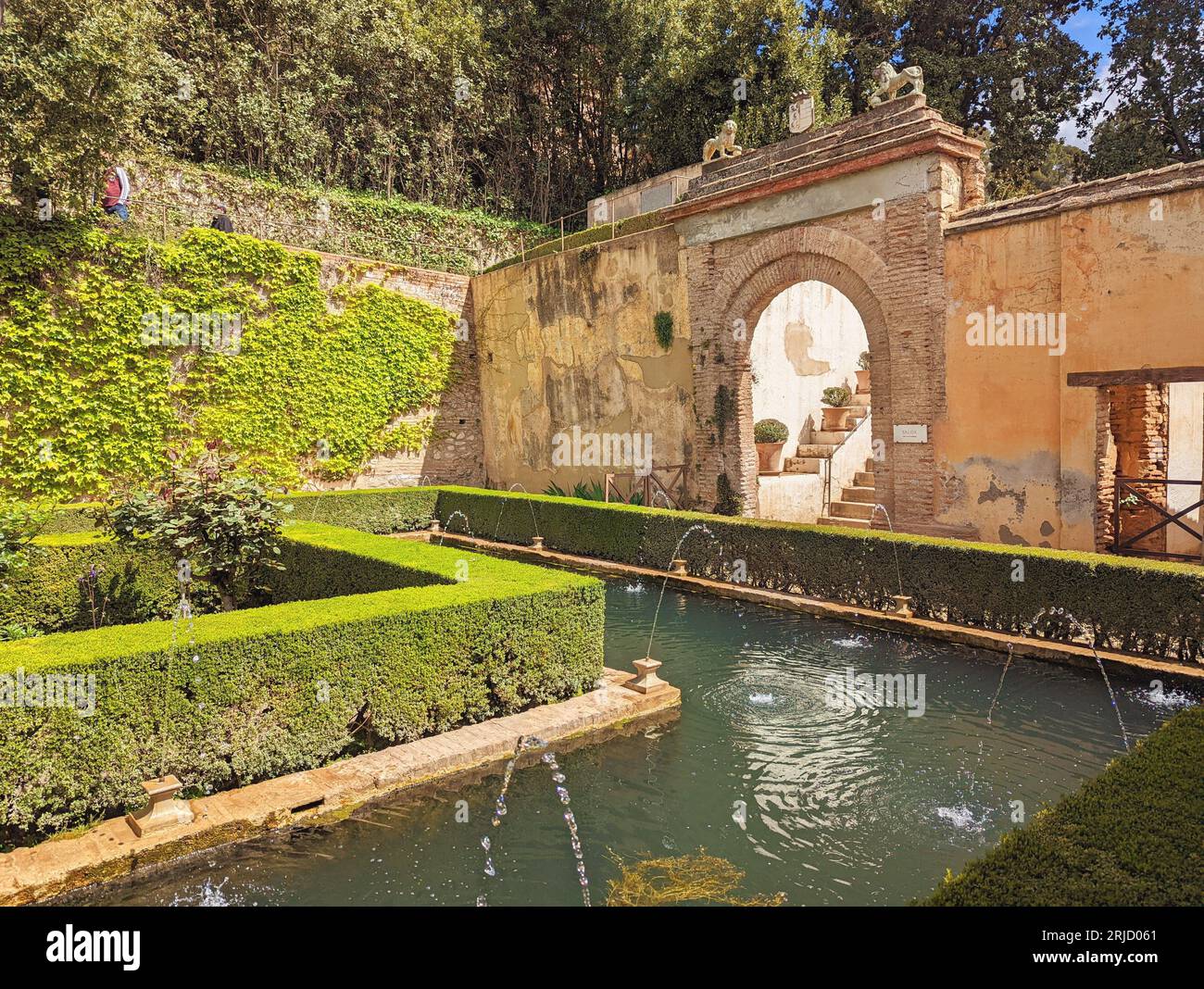 A stunning pool with cascading fountains in the iconic Alhambra Palace ...