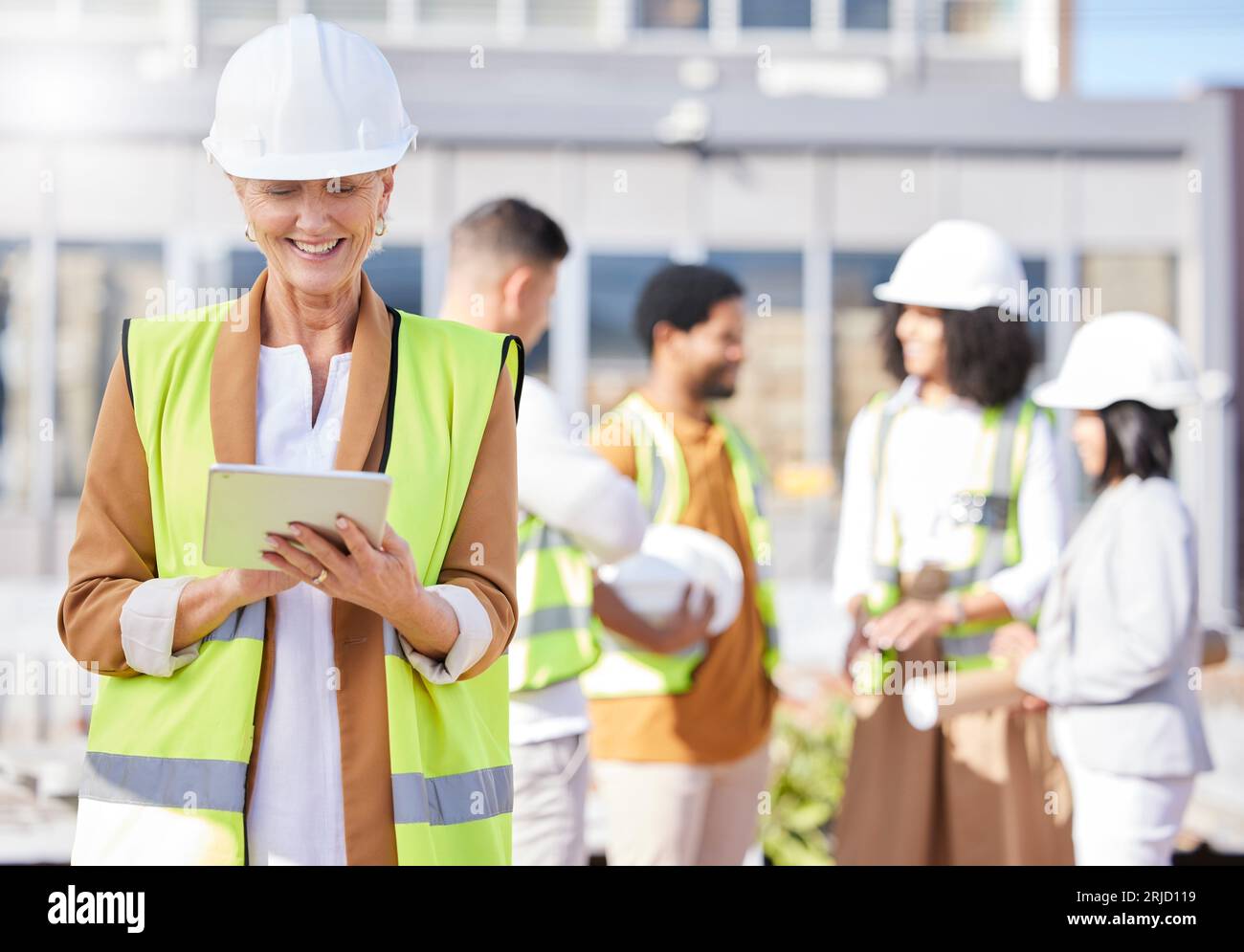 Tablet, architecture and a senior woman construction worker on a ...