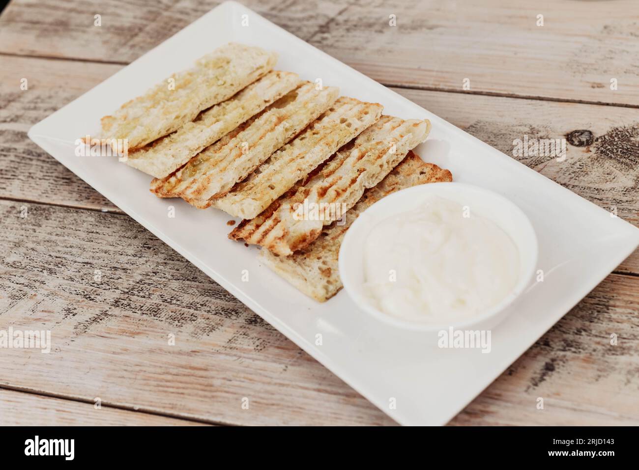 Ration of toasted bread with garlic mayonnaise, typical Mediterranean ...