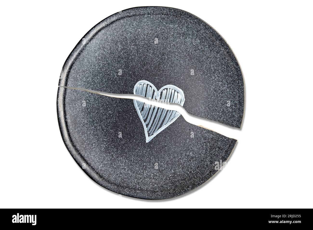 Broken ceramic plate with a drawn heart symbol isolated on a white ...