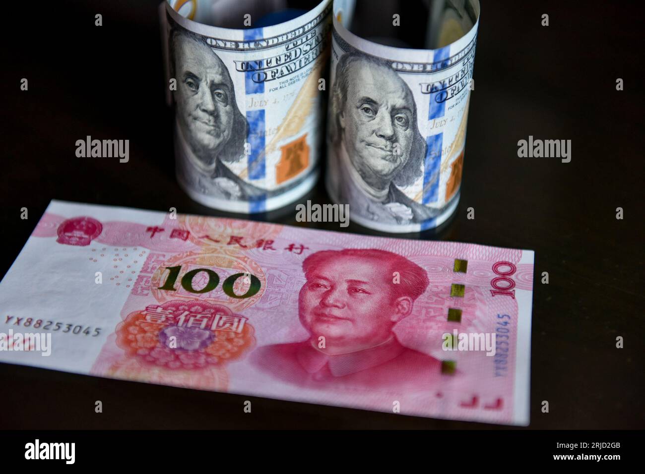 In this photo illustration, $100 and 100 Yuan bills seen displayed on a ...