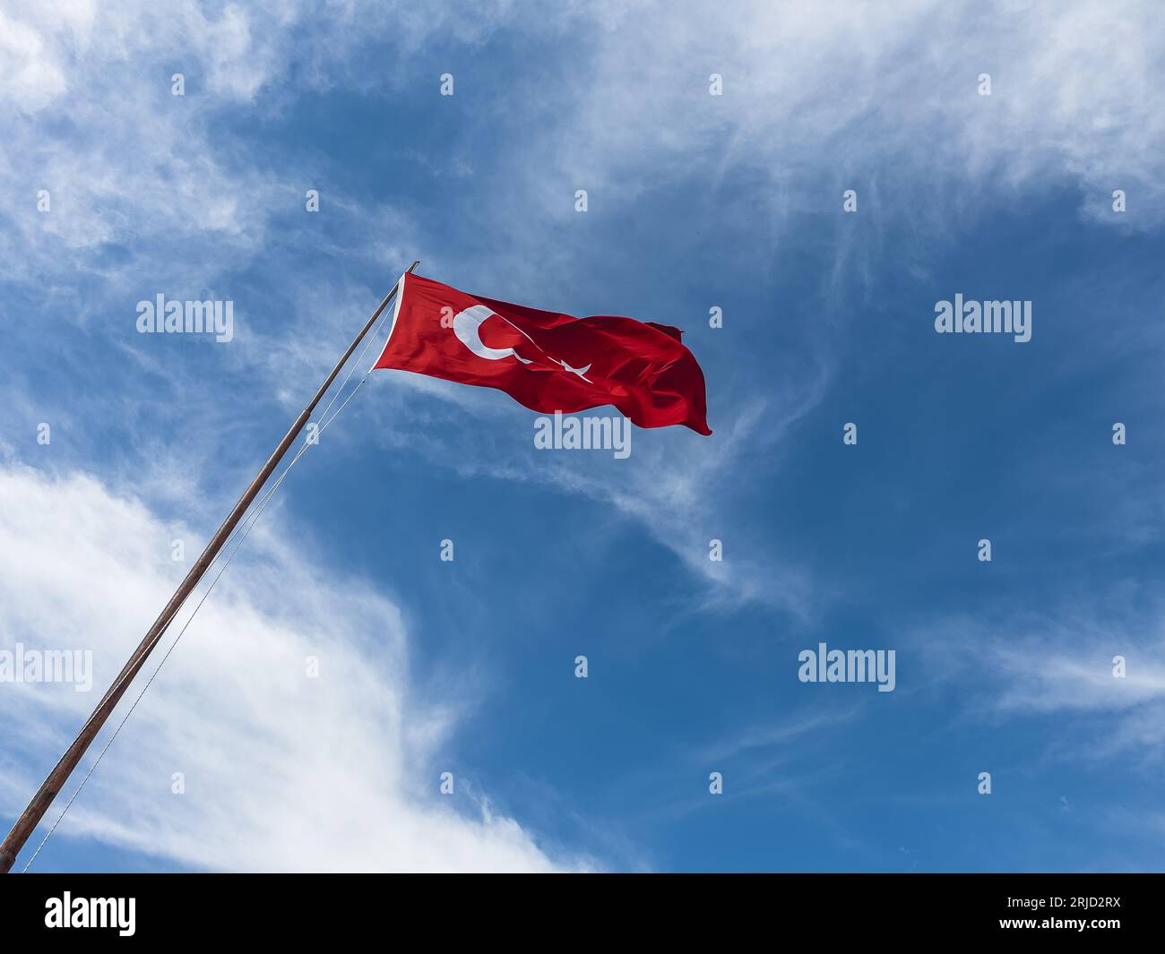 Turkish flag hoisted on flagpole , red turkish flag in front of blue ...