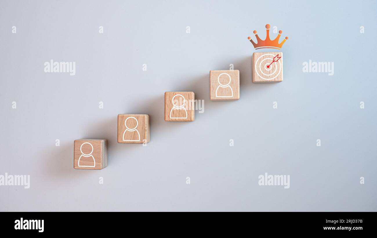 wooden block which prints a target icon and business symbol on white ...