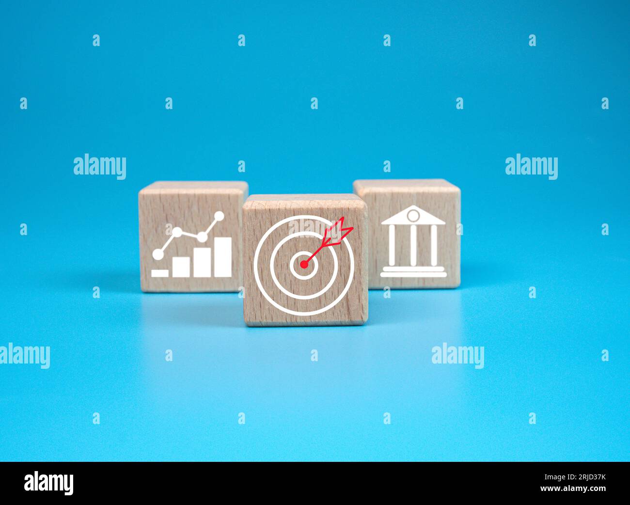 wooden block which prints a target icon and business symbol on light ...